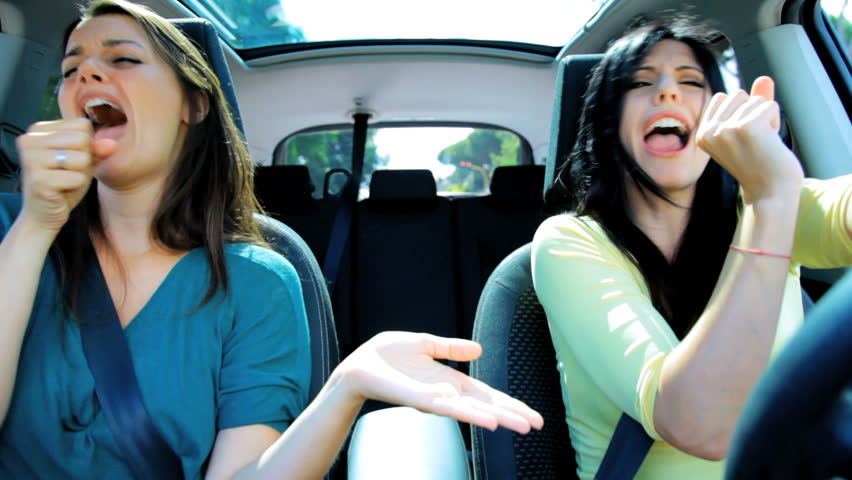 Two Beautiful Women Singing And Dancing Driving Car Stock Footage Video