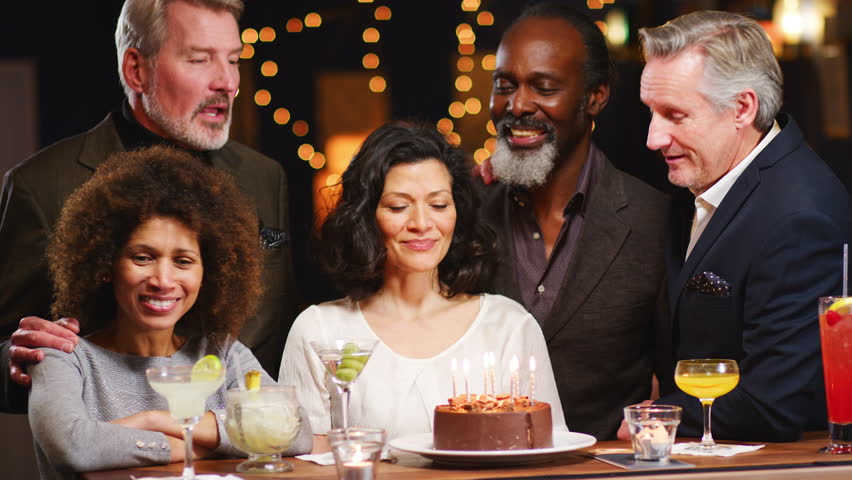 Middle Aged Woman Meeting Friends Around Table In Coffee Shop Stock ...