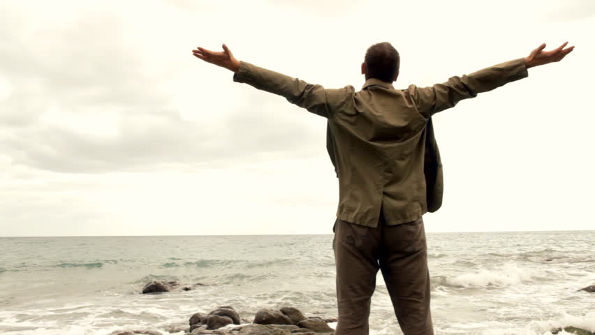 Stock video of man at the beach rising hands | 1040302 | Shutterstock