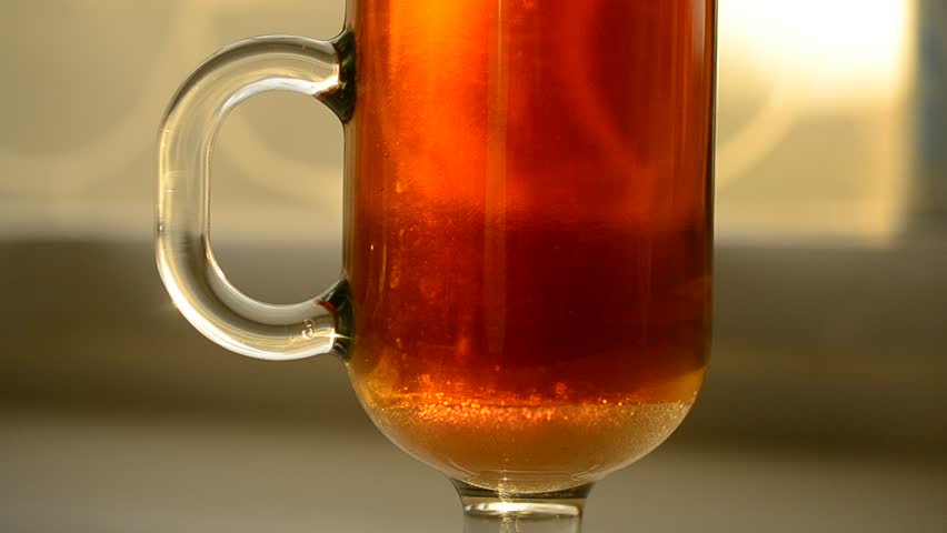 Stock Video Clip of Preparing tea: stirring sugar in black tea ...