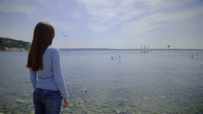 Stock Video Clip of Woman looking in distance at sea 4K. | Shutterstock