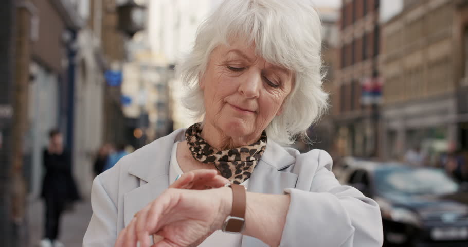 Slow Motion Portrait Of Happy Mature Old Woman In City Using Smart ...