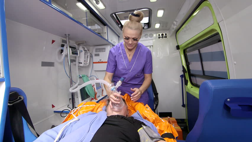 EMT Paramedic Provide Medical Care To Critical Senior Patient Wearing ...