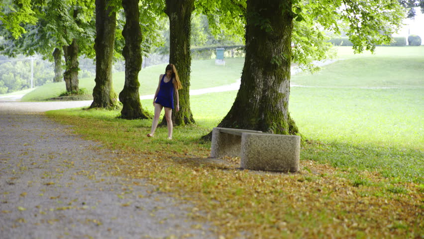 Stock Video Clip of Girl in park free walking around 4K. | Shutterstock