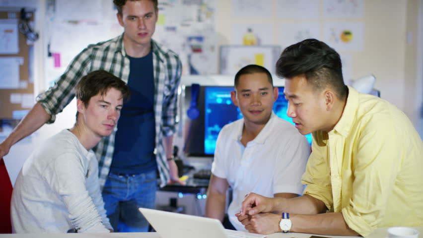 Stock Video Clip of 4K Group of young male computer programmers ...