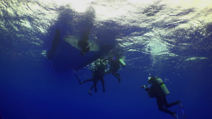 Athletic Young Man Jumping From Cliff Into Ocean Sea Water Muscular ...