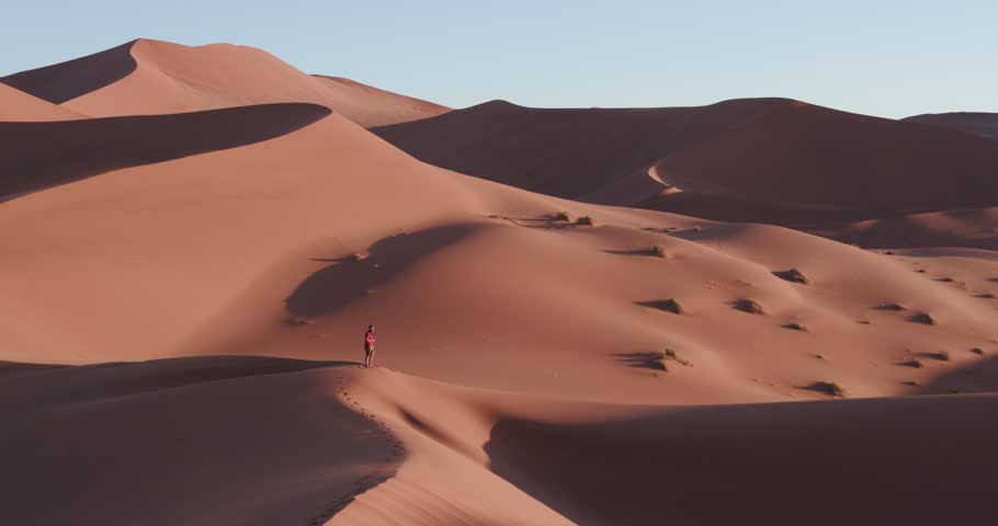4K Aerial View Of Male Tourist Walking Over The Sand Dunes In The Namib ...