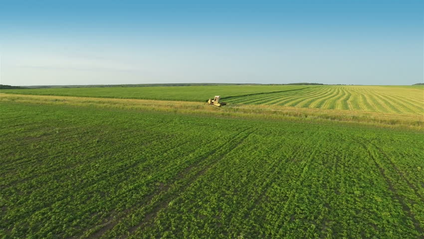 Aerial Of Tractor Mowing Grass Helicopter View And Low Fly Over On A ...