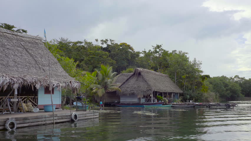 Two Lovely Bamboo Huts On Stilts Stand Over A Pond Near A Marsh In ...