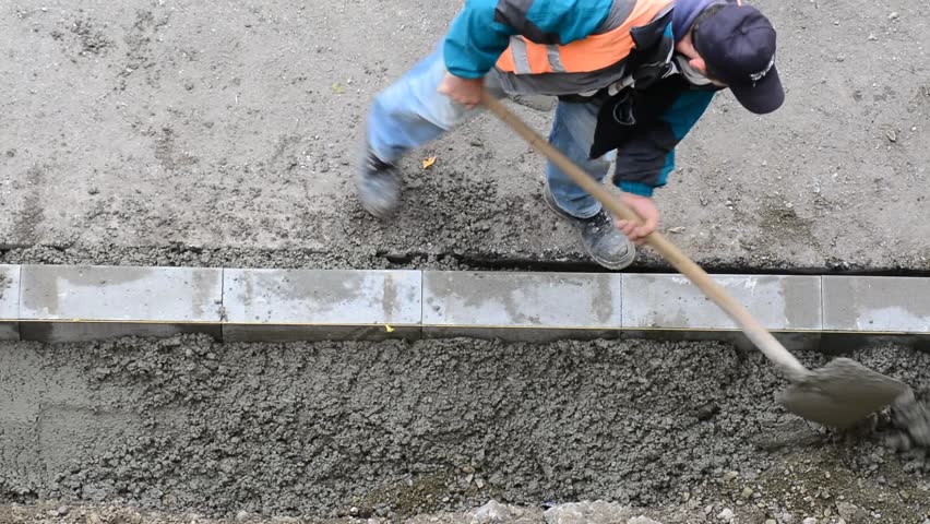 Workers Working On Construction Site, A Laborer Pulling The Hose Tor ...