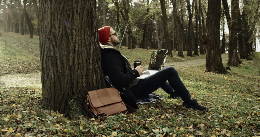 Man Sitting Under Tree Stock Footage Video | Shutterstock