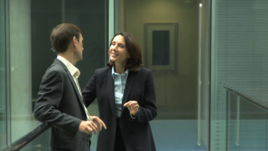 Stock Video Clip of MEDIUM SHOT MALE AND FEMALE BUSINESS CONVERSATION ...