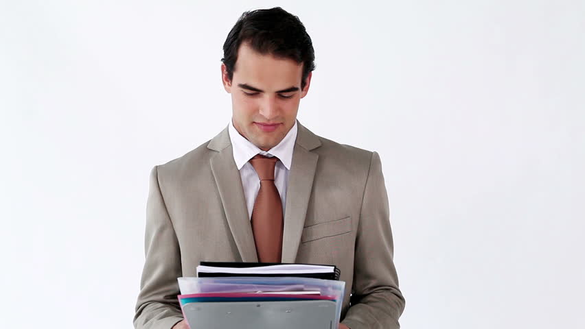 Stock Video Clip of Happy businessman holding files against a white ...