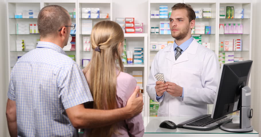 Pharmacist Advising Customer On Medicine In The Hospital Pharmacy Stock ...