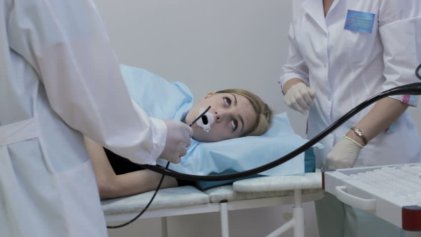 Doctor Makes An Endoscopy Through The Mouth Of A Young Girl Pulls Out