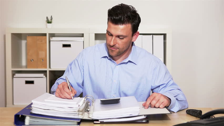 Stock video of manager using calculator while working at | 2276102 ...