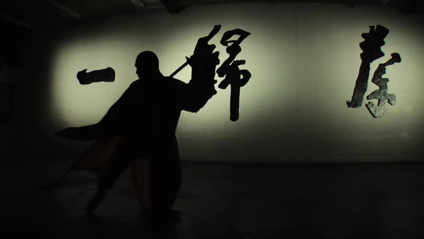 A Shaolin Monk Demonstrates In Silhouette An Ancient Form Of Kung Fu ...