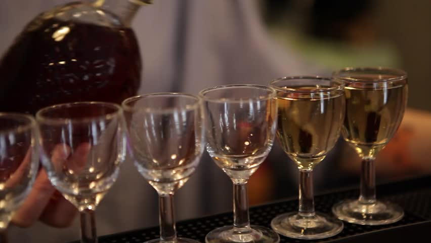 Cognac. Pouring Brandy From A Bottle To A Glass Over Fireplace ...