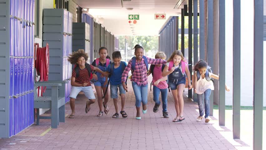 Group Of Elementary School Kids Running In A School Corridor Stock ...