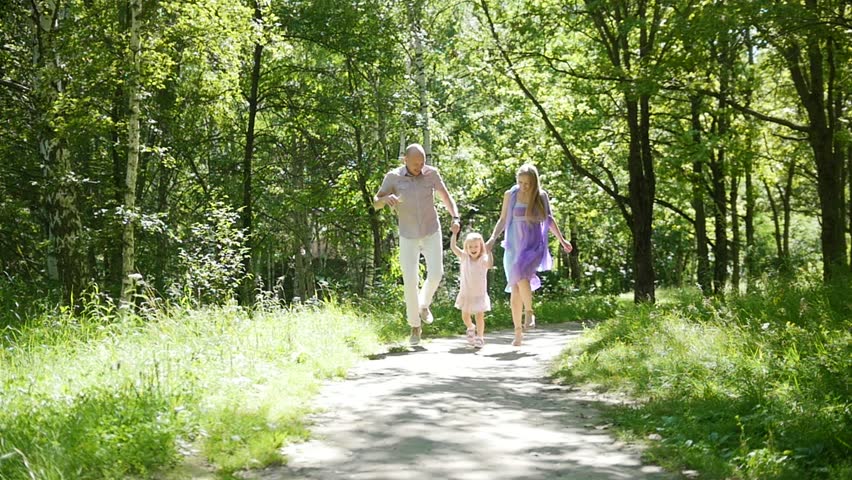 3 Happy Friends Walk Down Path Through Park Toward Camera Stock Footage ...