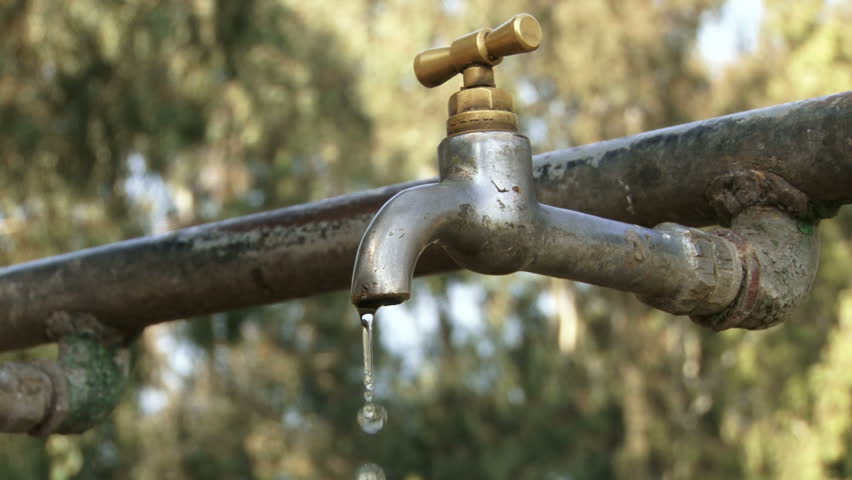 Man Opening An Old Fashioned Fountain Tap. Old Faucet Dripping. Iron ...