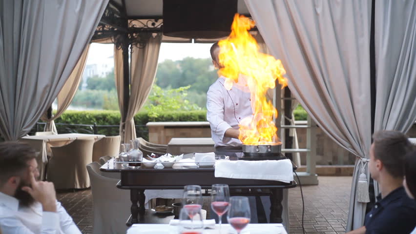 Team Of Professional Chefs Preparing And Cooking Food In A Commercial ...