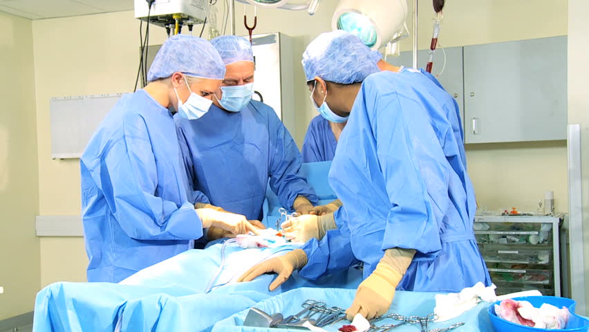 Stock video of senior doctor performing operation using surgical ...