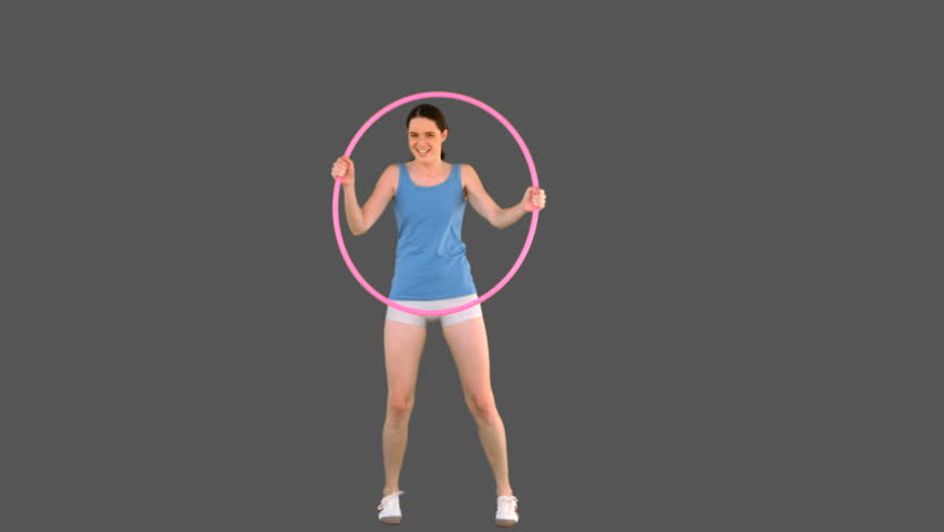 Young Model In Sportswear Exercising With Hula Hoop On Grey Background ...