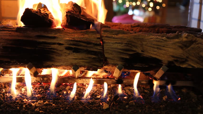 Man Stoking Fire With Stick - Wood Burning Fire With Flames In ...