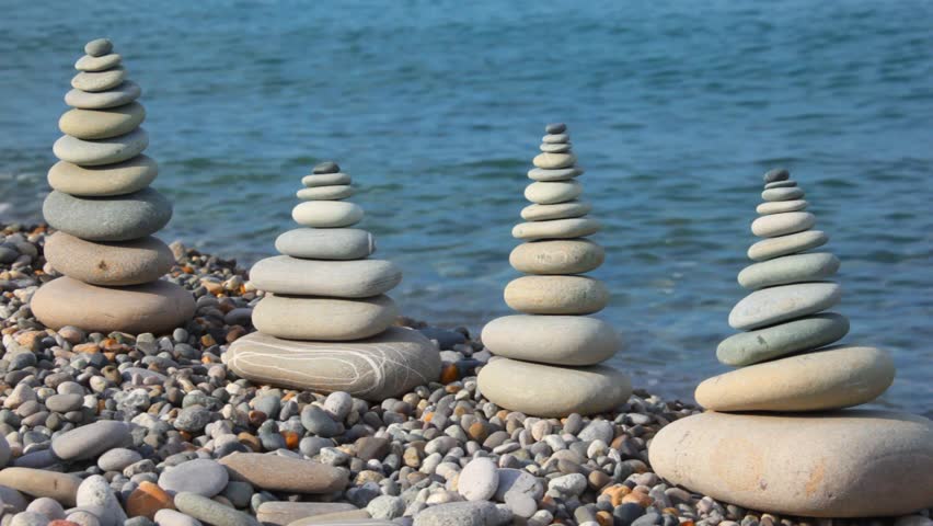Pebble Stack On The Stone Seashore, Sea In Background Stock Footage ...