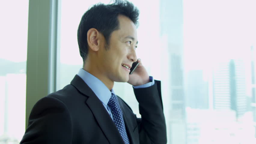 Stock Video Clip of Successful young Asian Chinese businessman talking ...