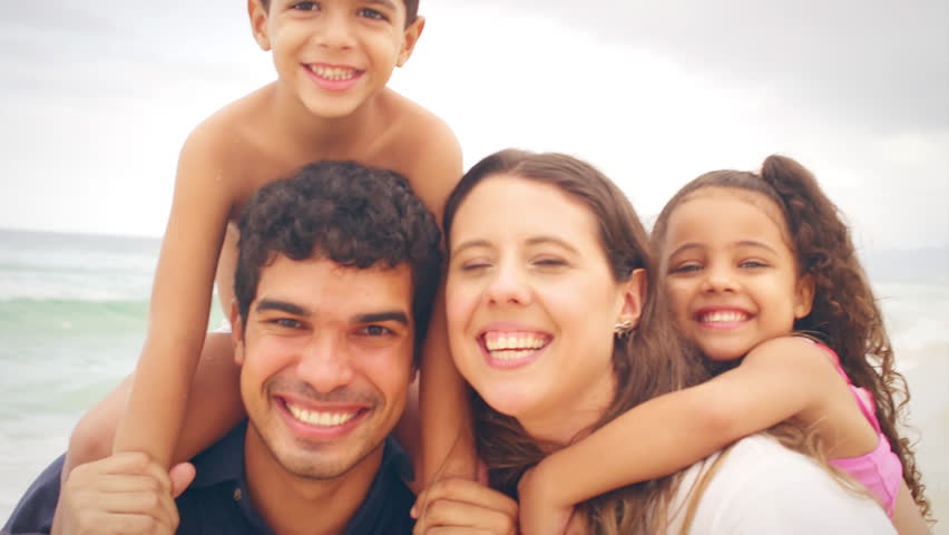 Stock Video Clip of Family embrace and smiles on a beach | Shutterstock