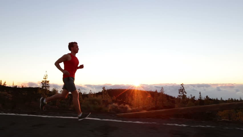 Running Shoes And Legs In Action Closeup. Male Runner Jogging On Road ...