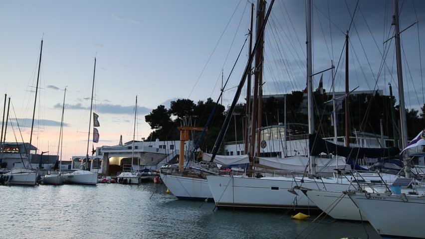 A Lot Of Beautiful Sailing Yachts And Catamarans Moored To The Pier In ...